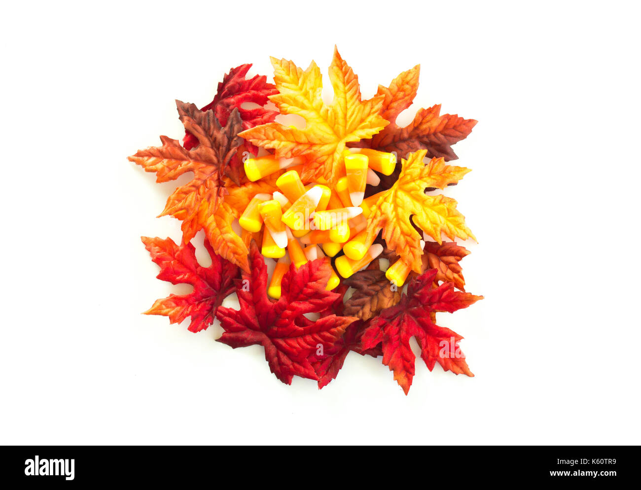 candy corn and colorful autumn leaves isolated on white Stock Photo - Alamy