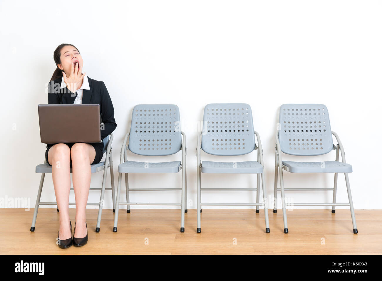 lovely young business female student sitting on wood floor chair ...