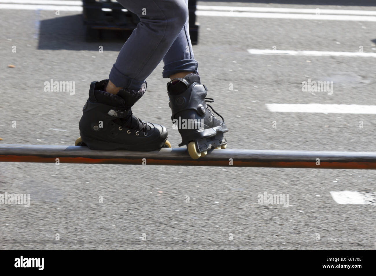 Teen with roller skates performing a stunt on a half pipe ramp Stock ...
