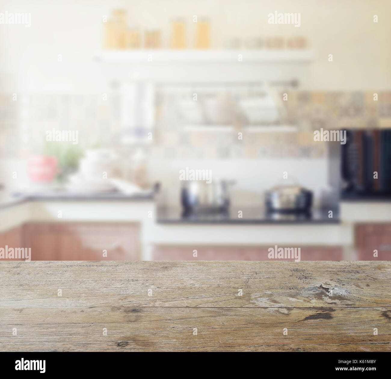 wooden table top with blur of modern kitchen interior for background ...