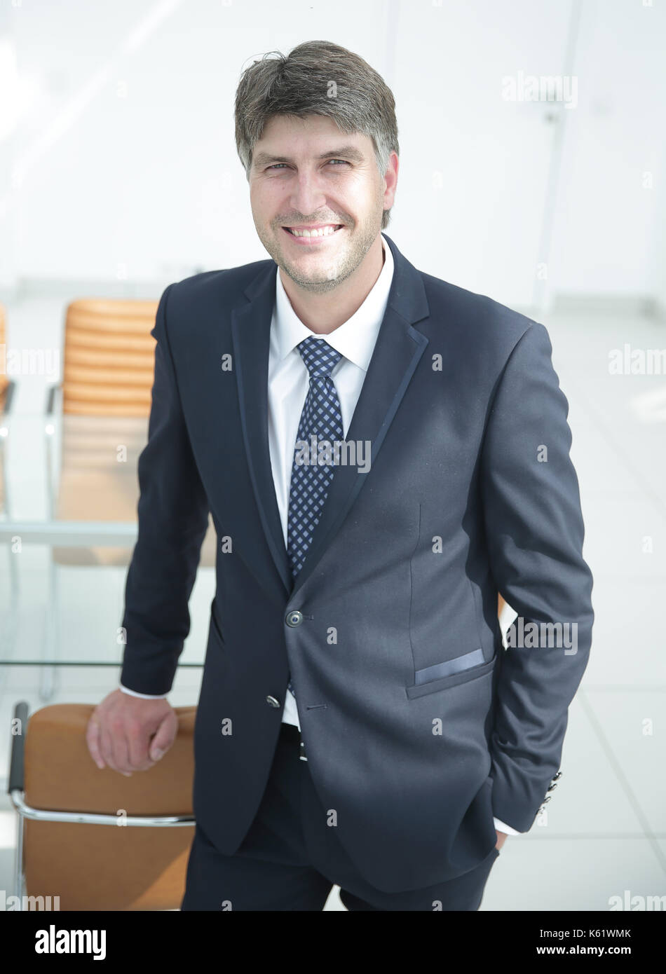 successful businessman standing by the desk Stock Photo - Alamy