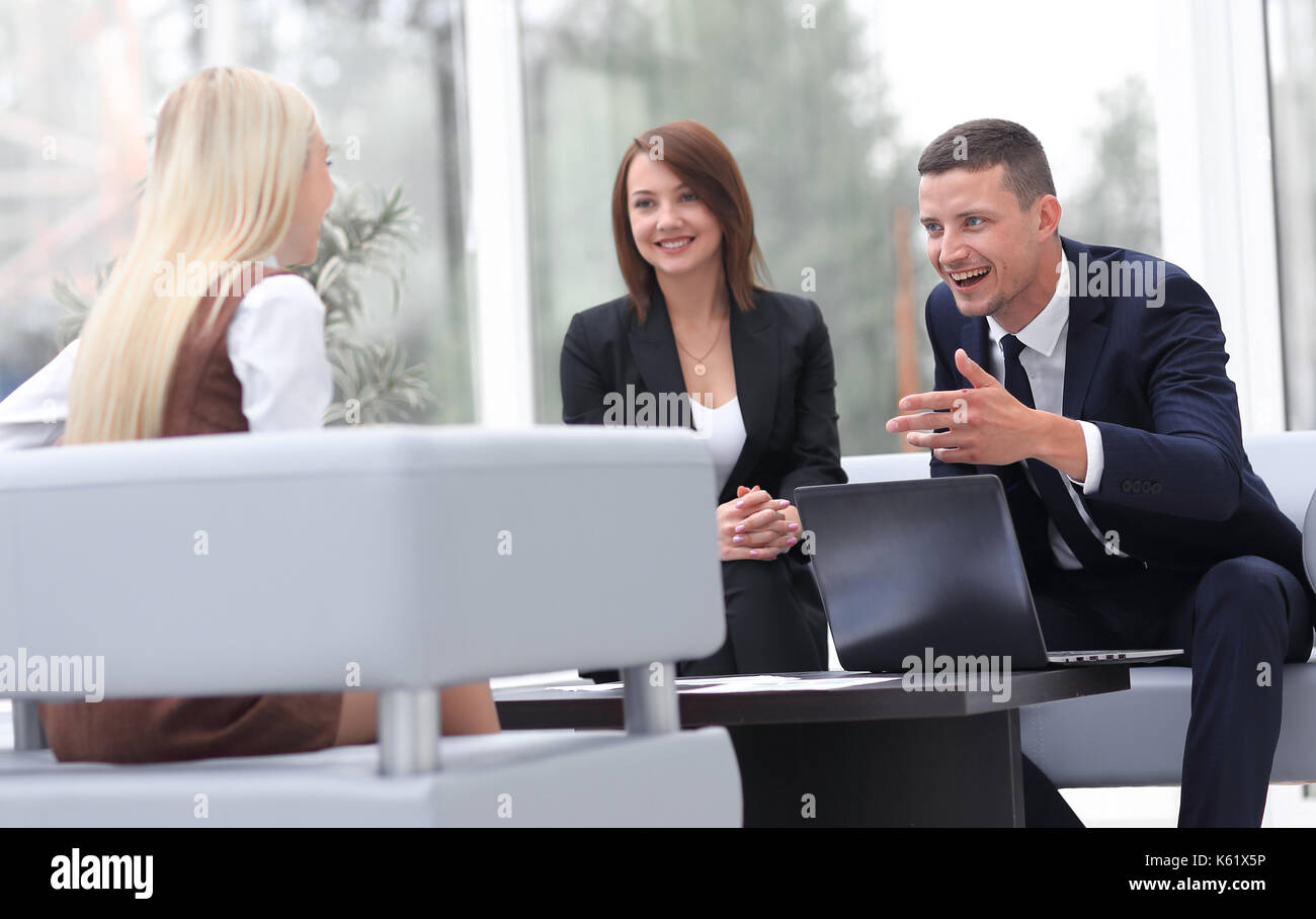 business team talking in office lobby Stock Photo - Alamy