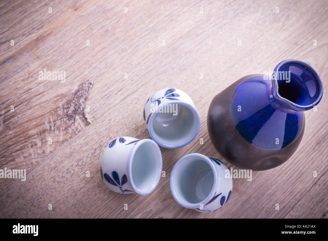 Japanese Sake drinking set on old wood texture background (focus on ...
