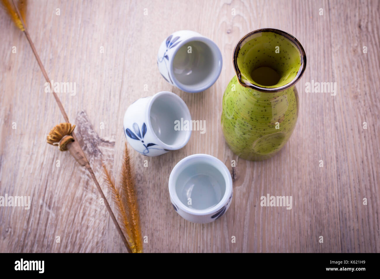 Japanese Sake drinking set on old wood texture background (focus on ...