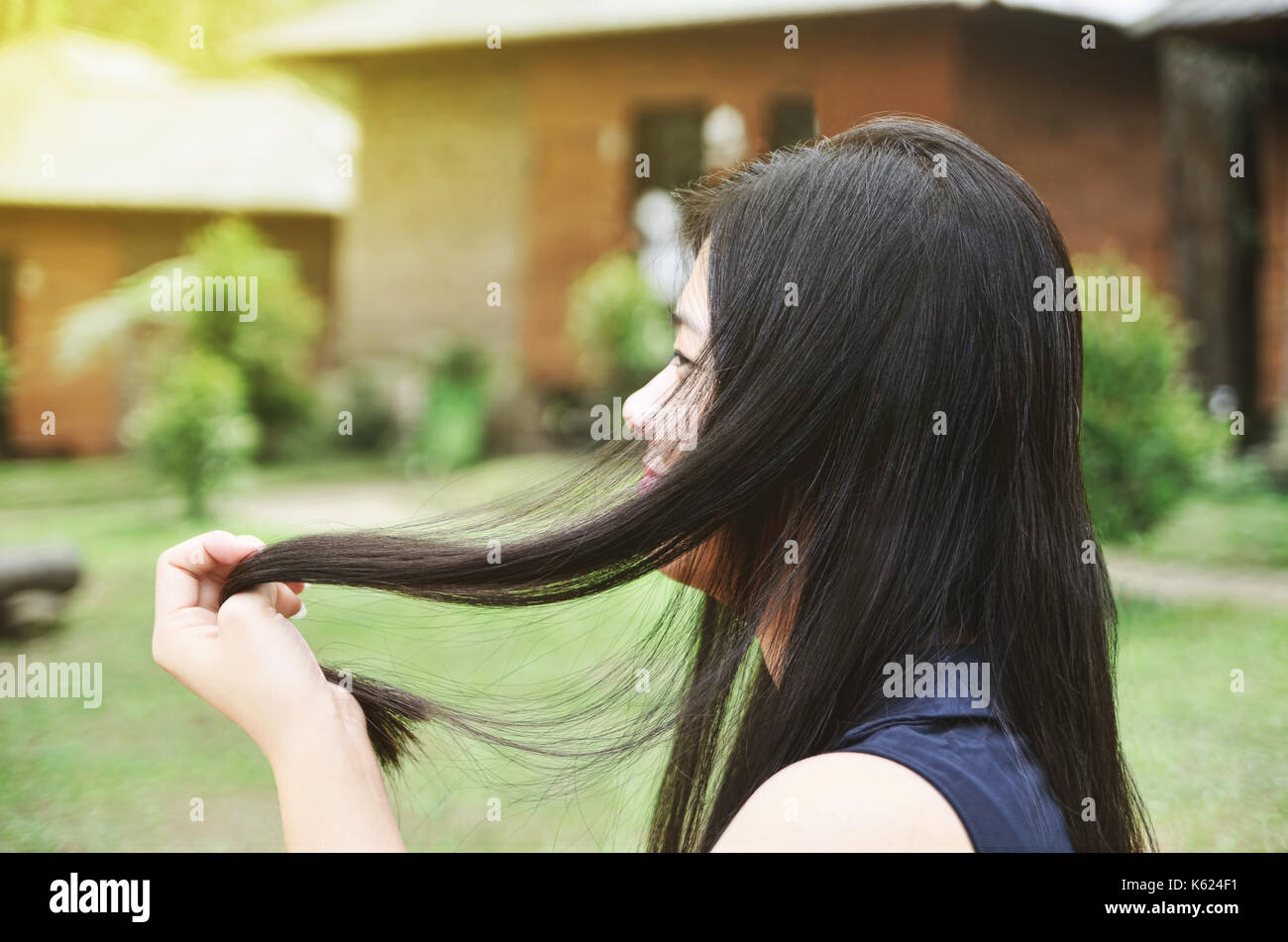 Photograph of a girl touching her hair Stock Photo - Alamy