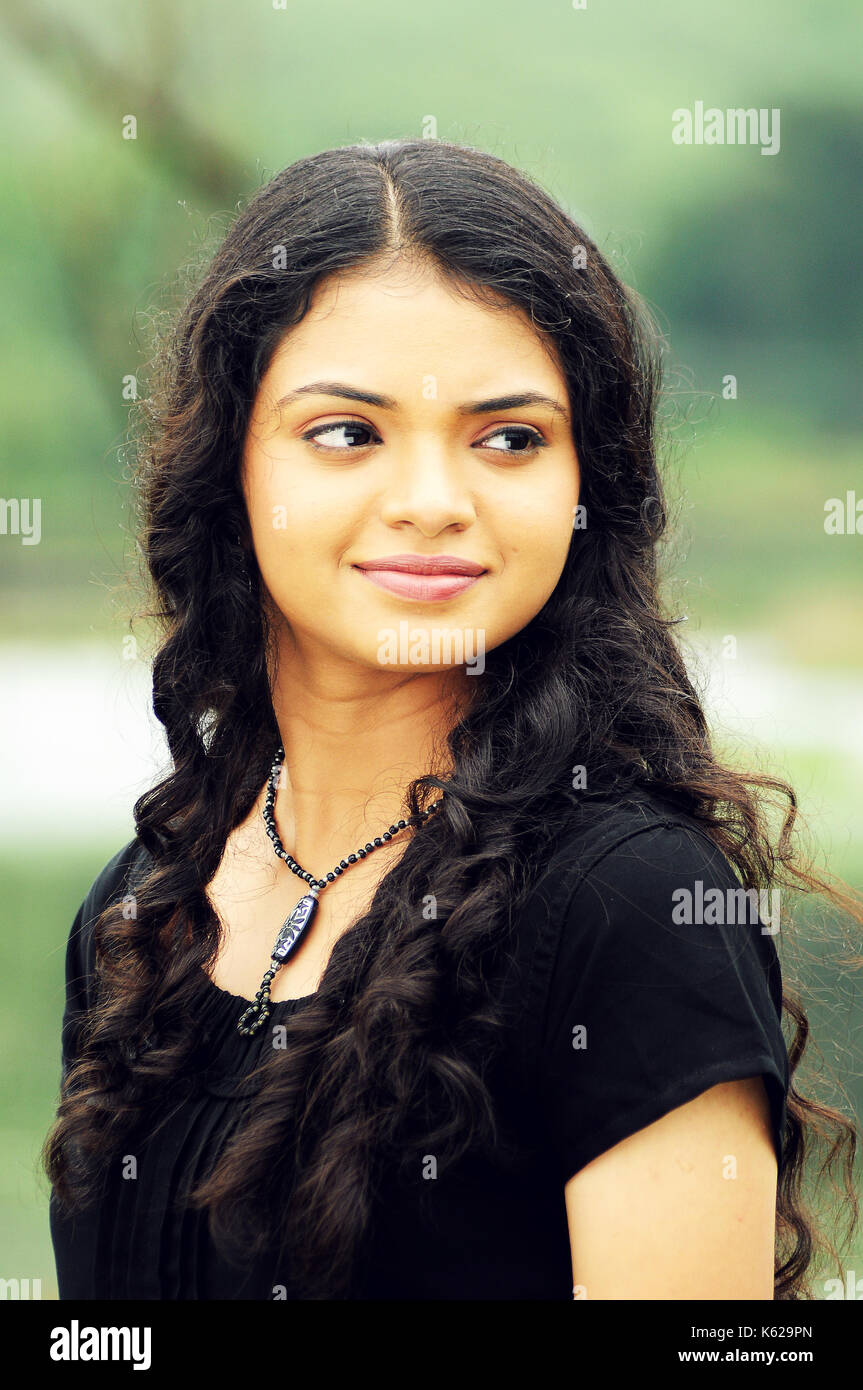 Cute young woman looking at camera Stock Photo - Alamy