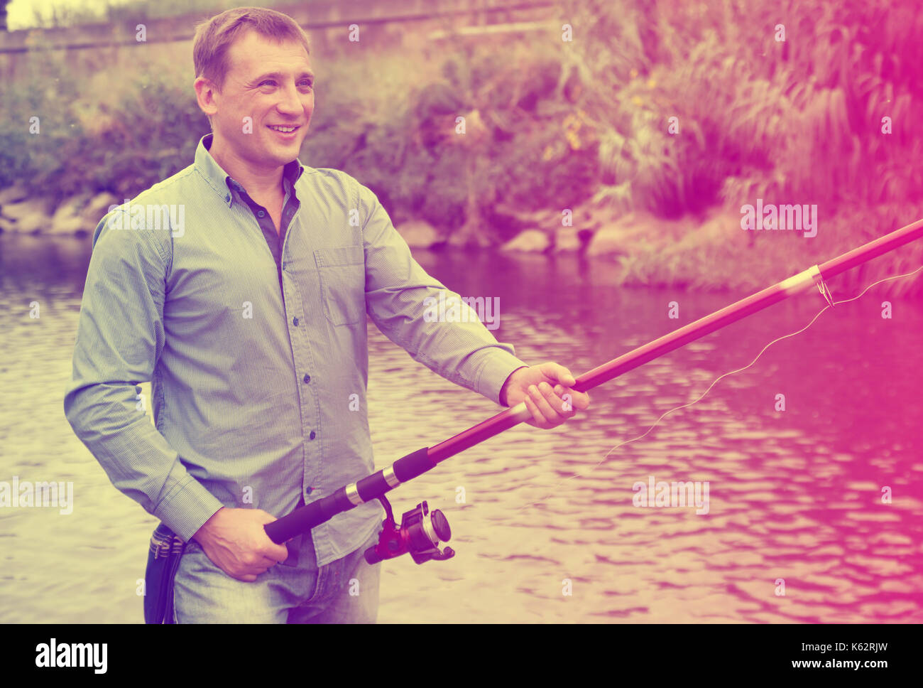 Man pulling fishing tackle hi-res stock photography and images - Alamy