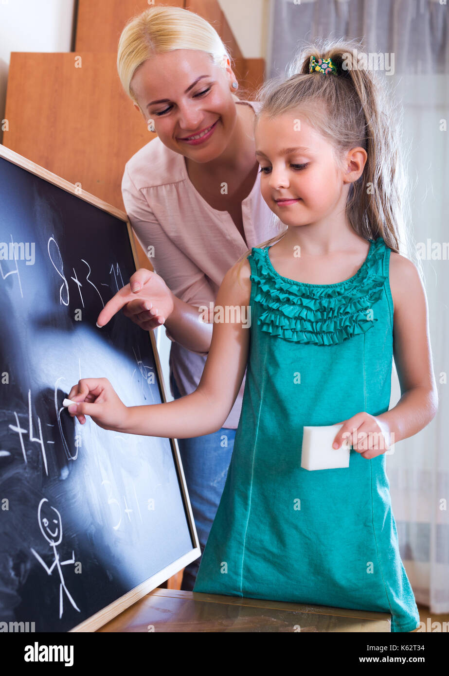 Friendly young woman introducing numbers to small girl Stock Photo - Alamy