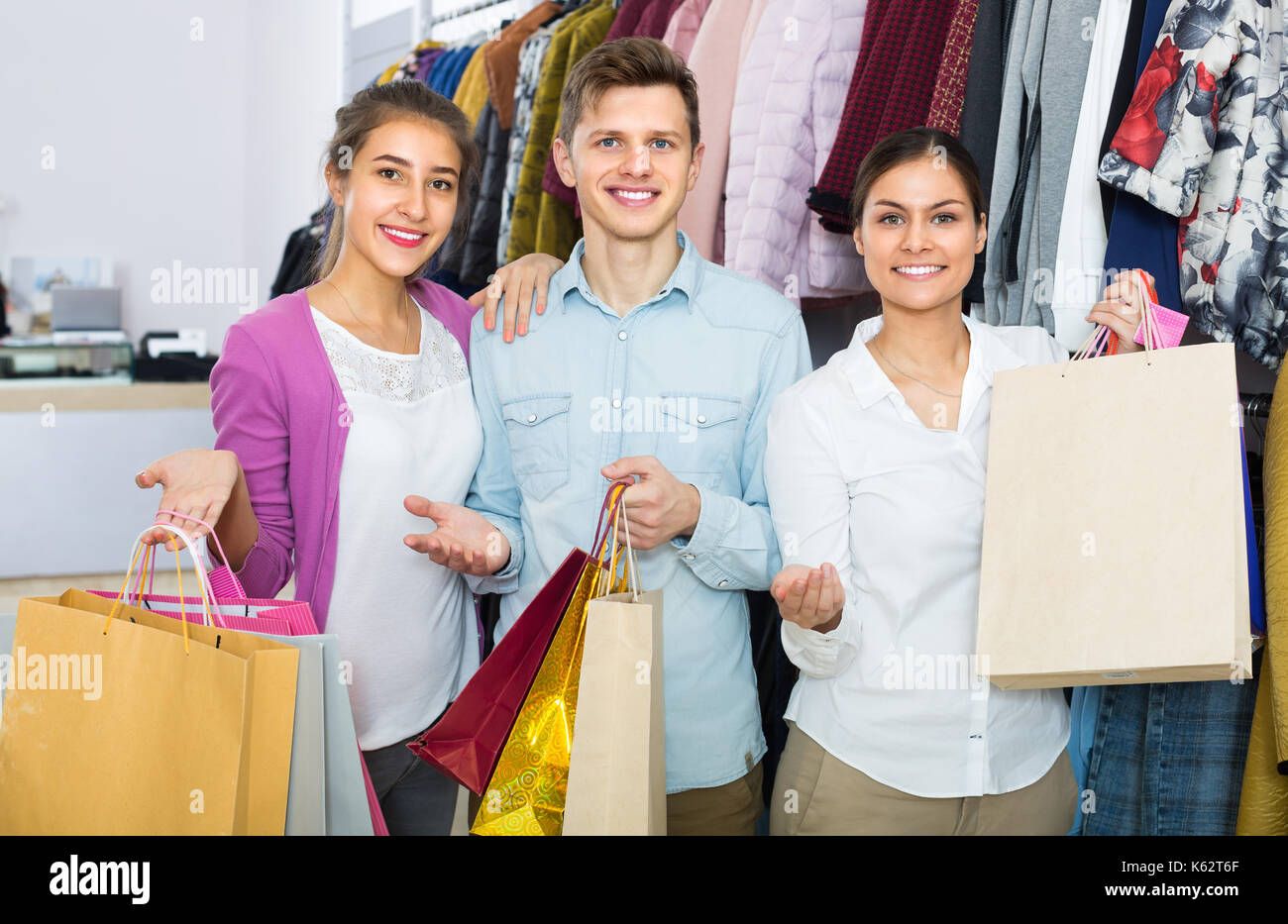 Happy young people with purchases in apparel shop Stock Photo - Alamy
