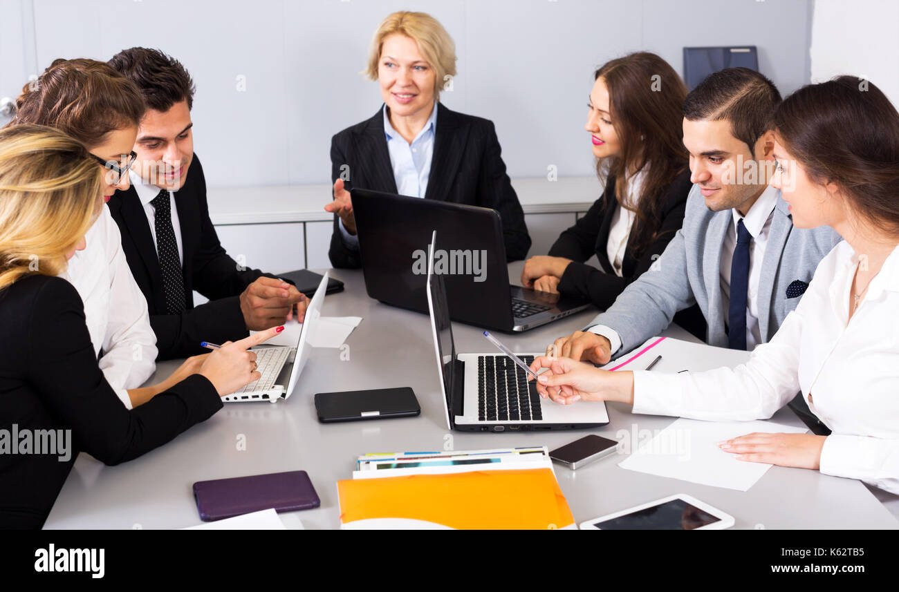 Smiling members of the multinational business meetings at work in ...