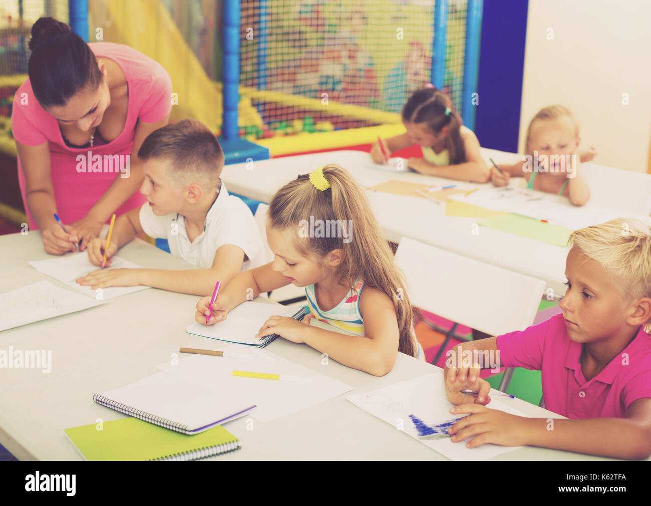 cheerful primary school kids doing exercises at school lesson Stock ...