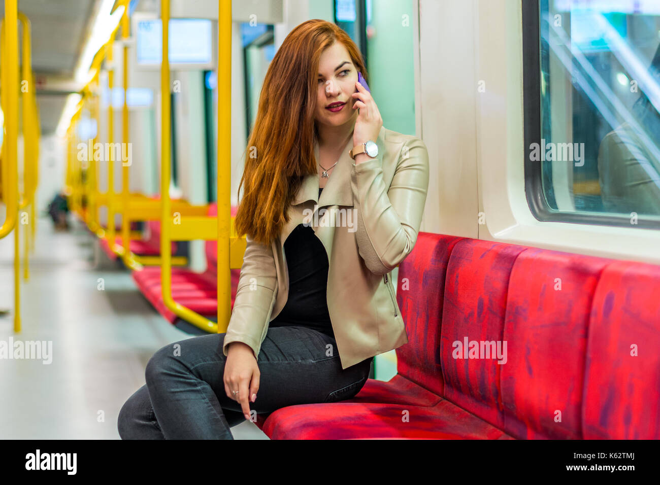 The girl speaks on a cell phone inside an empty subway train Stock ...