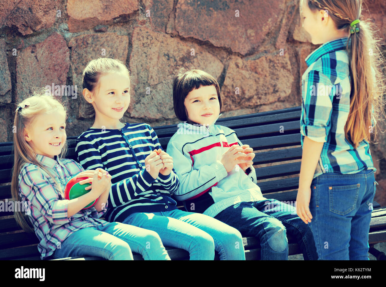 Little kids with small ball playing in city street Stock Photo - Alamy