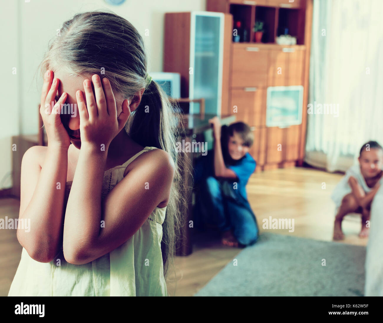 Joyful happy children hiding from girl with closed eyes during game ...