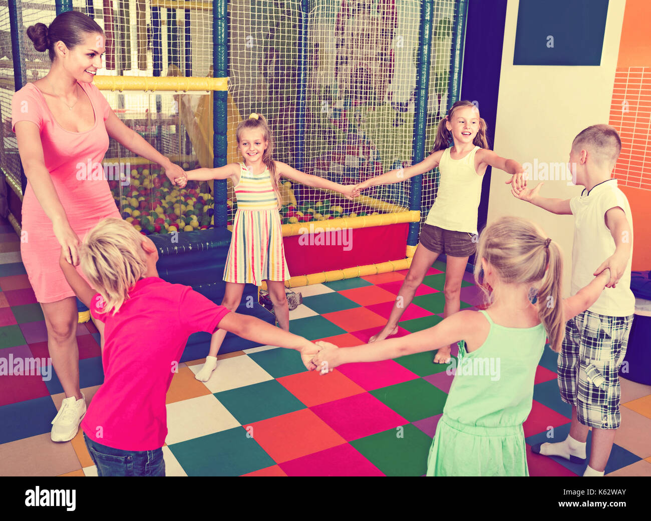 Active kids dancing with teacher in elementary school class Stock Photo ...