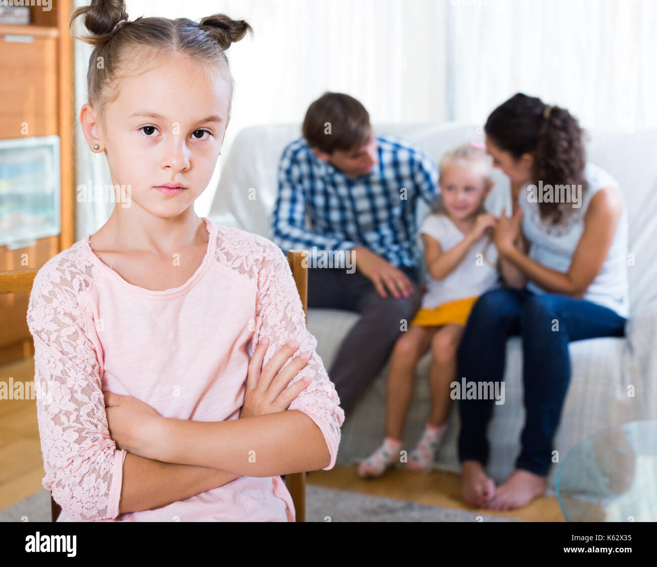 Little spanish girl sad because of jealous younger sister to parents ...