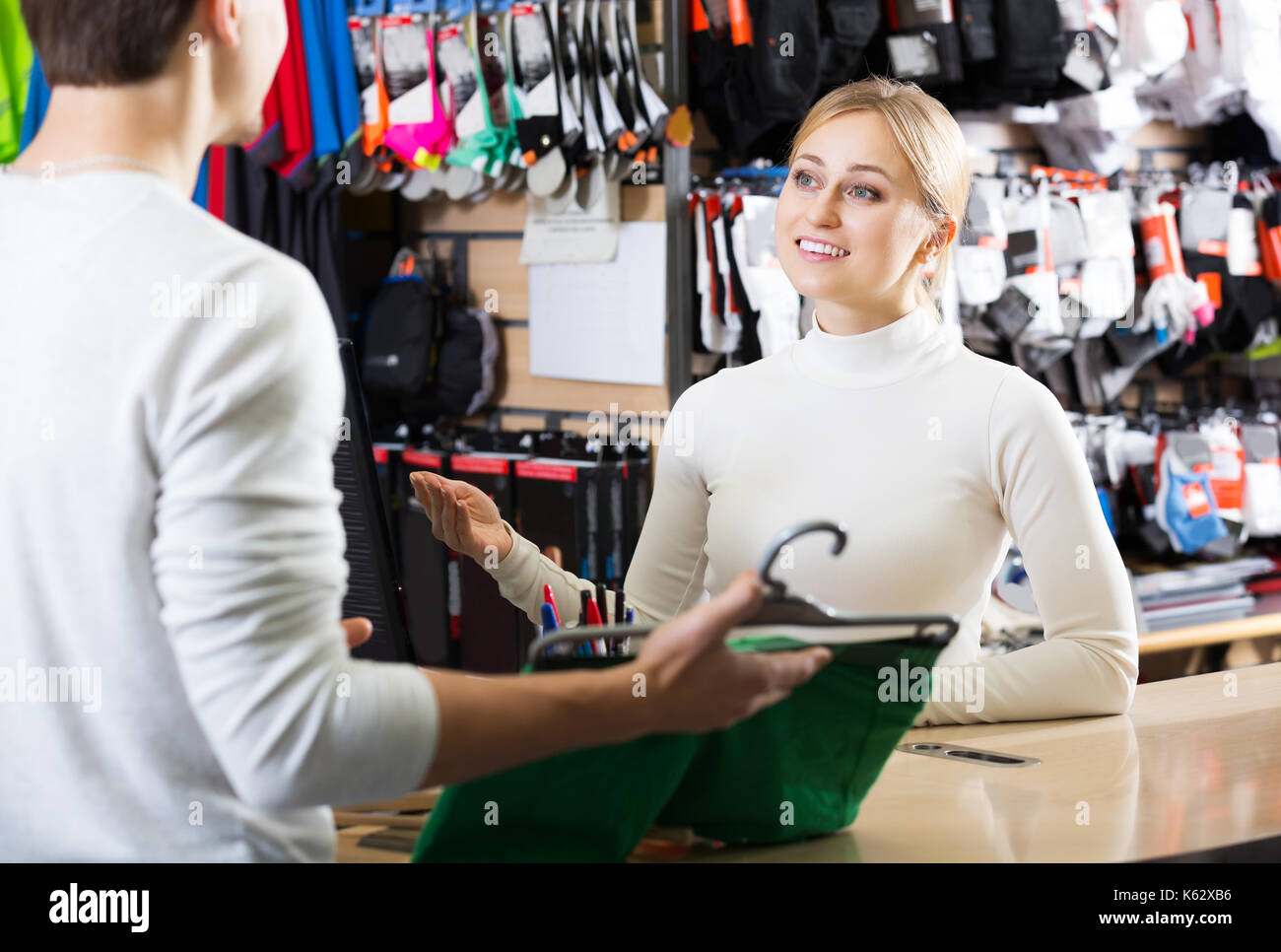 Portrait of two persons at the cashier in the clothing shop Stock Photo ...