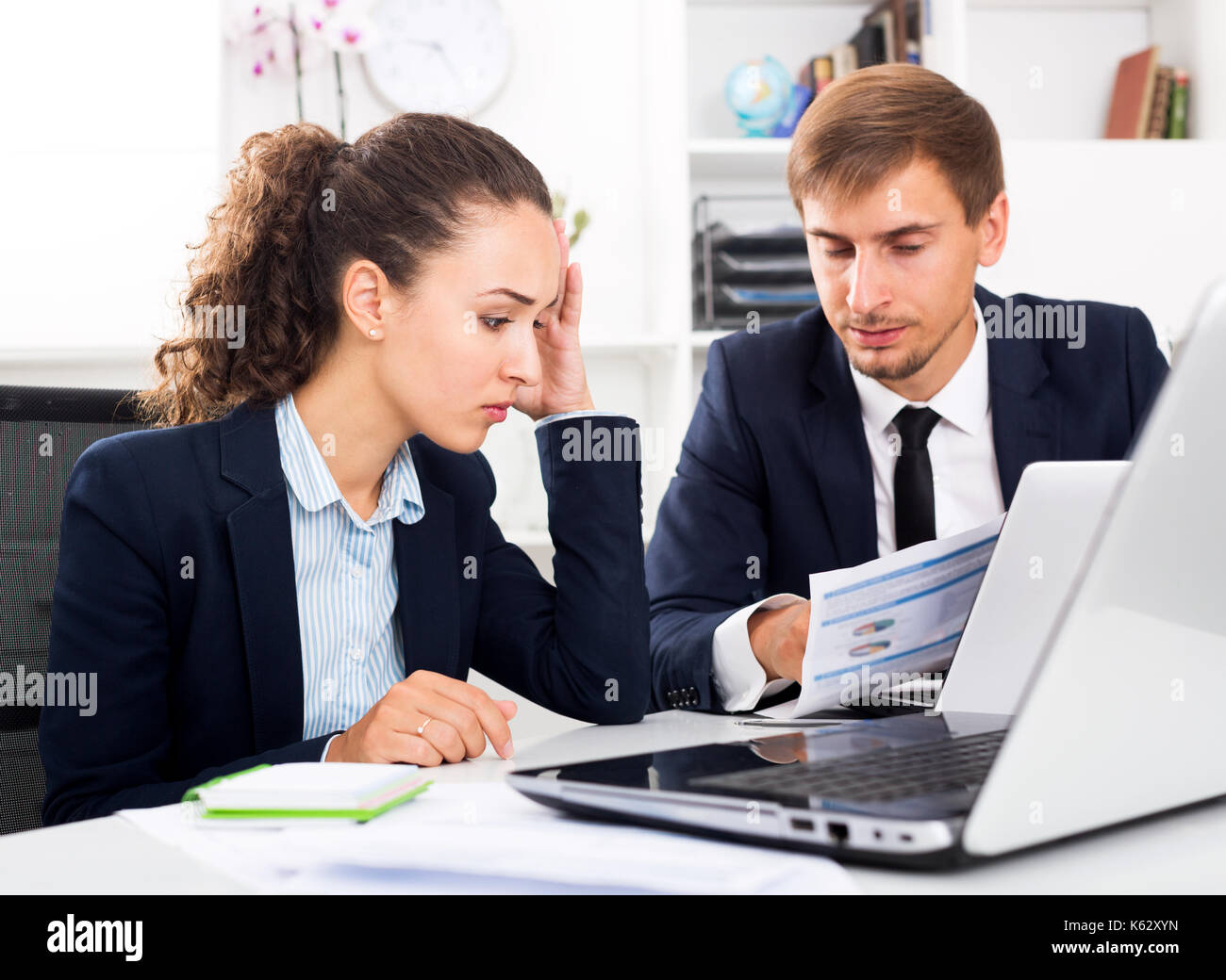 Portrait two annoyed business male and female assistants making mistake ...