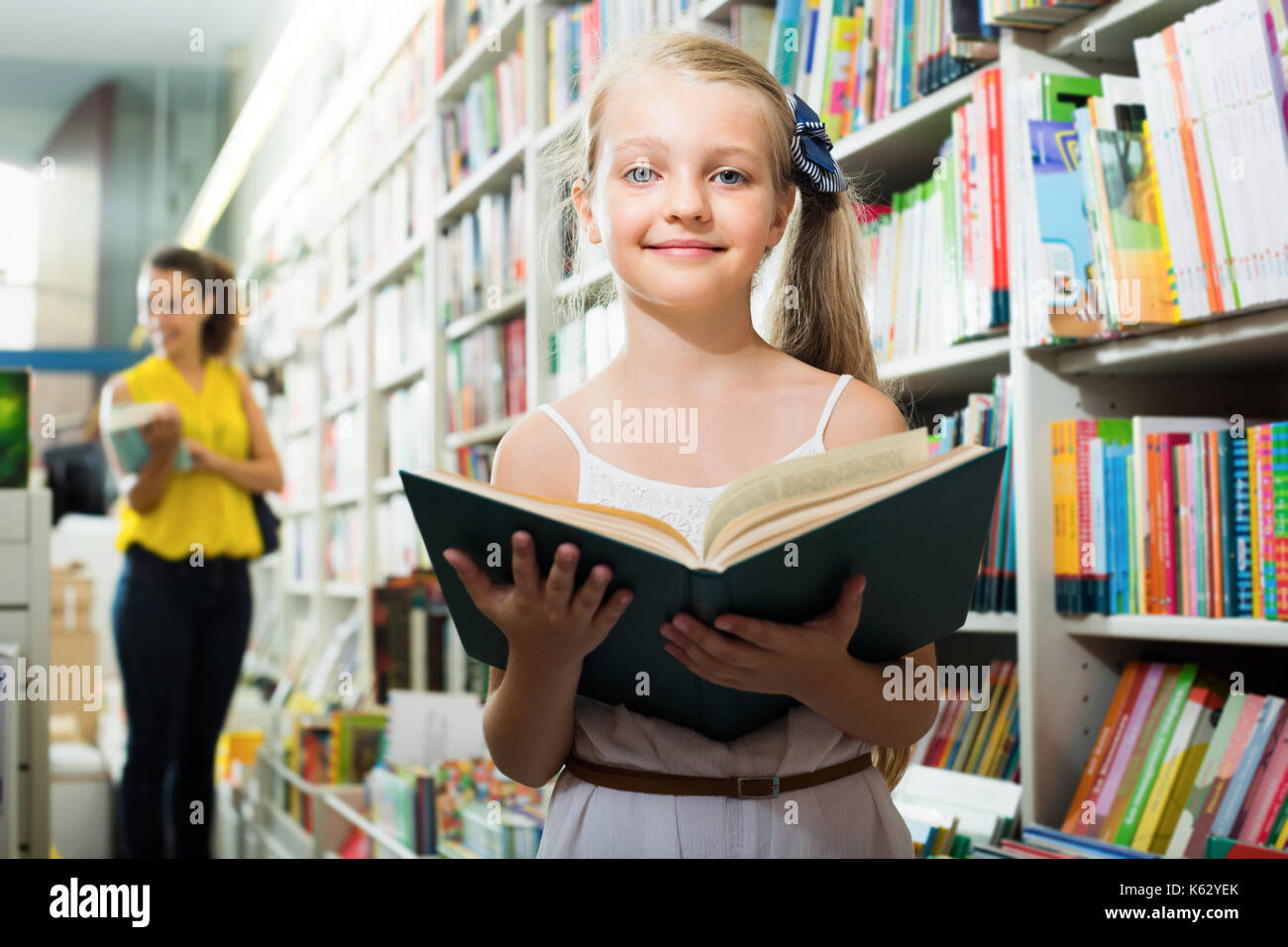 Happy girl collecting school hi-res stock photography and images - Alamy