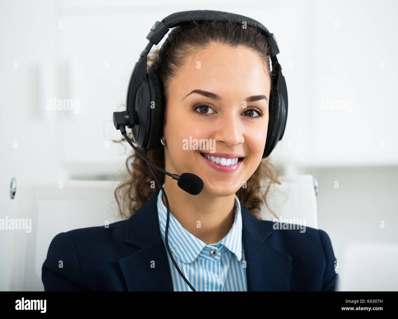Positive call center operator talking with client and smiling Stock ...