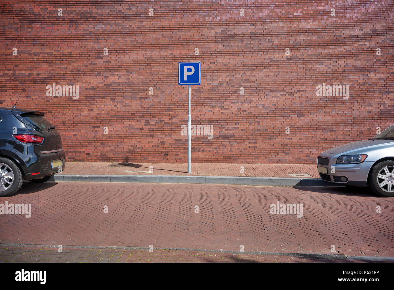 two cars parked in street with an open space Stock Photo - Alamy