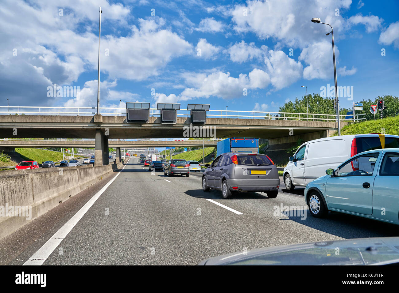 cars driving on an urban asphalt road Stock Photo - Alamy