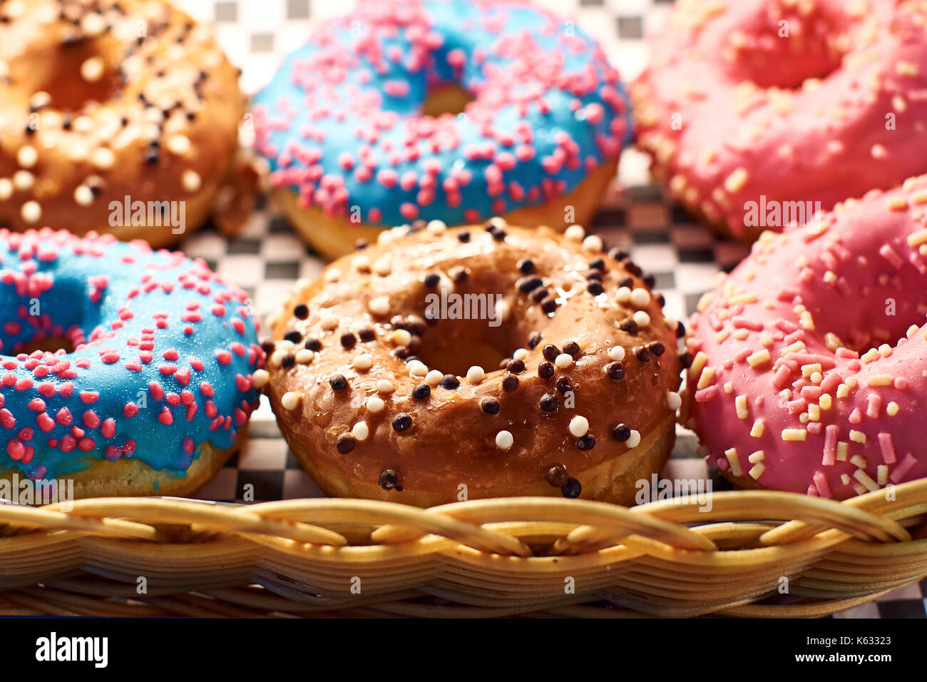 Colorful donuts in different colors in a whicker basket Stock Photo - Alamy
