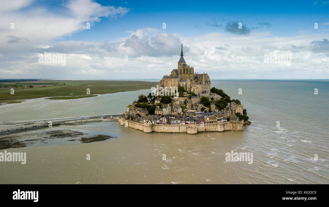 Panoramic view of famous "Le Mont Saint-Michel" tidal island on a sunny ...