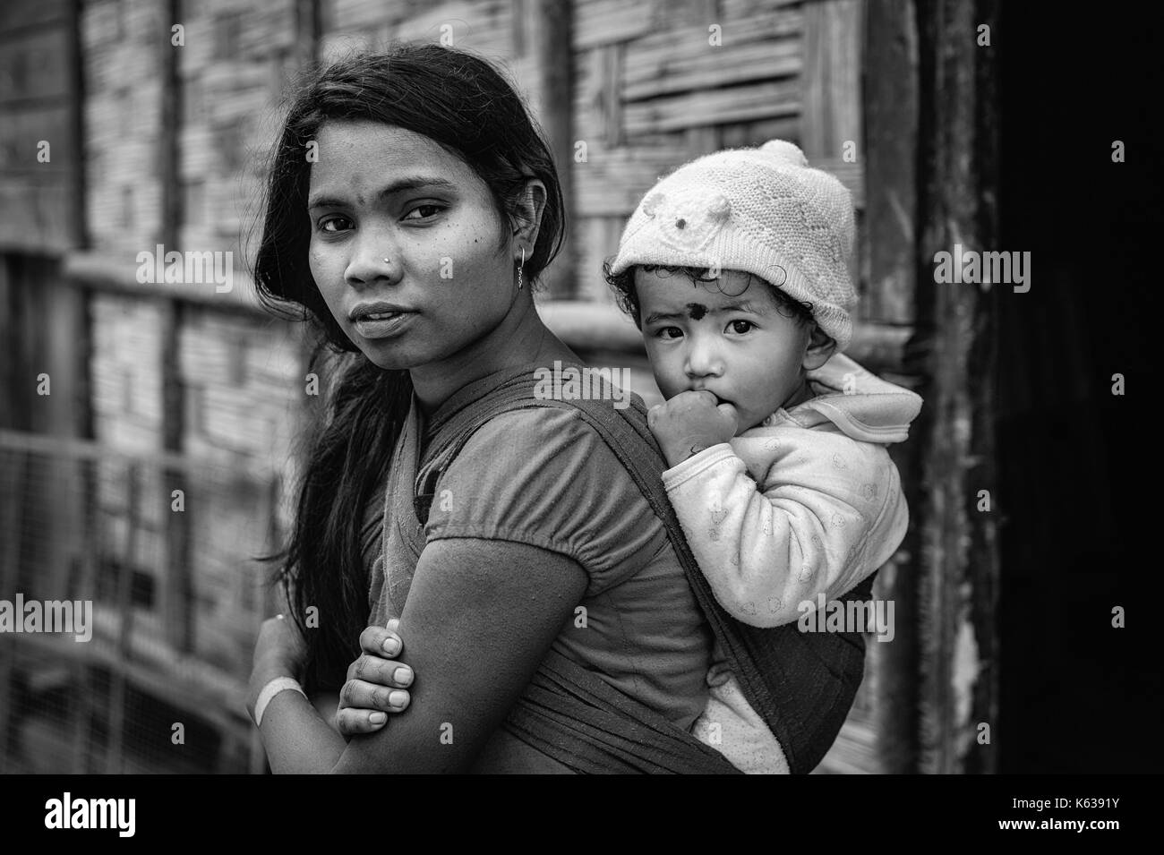 Female carrying baby on its back Black and White Stock Photos & Images ...
