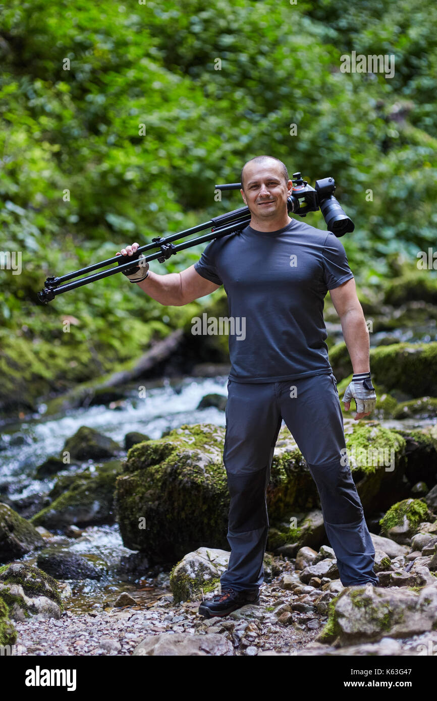 Professional nature photographer in a canyon by the river Stock Photo ...