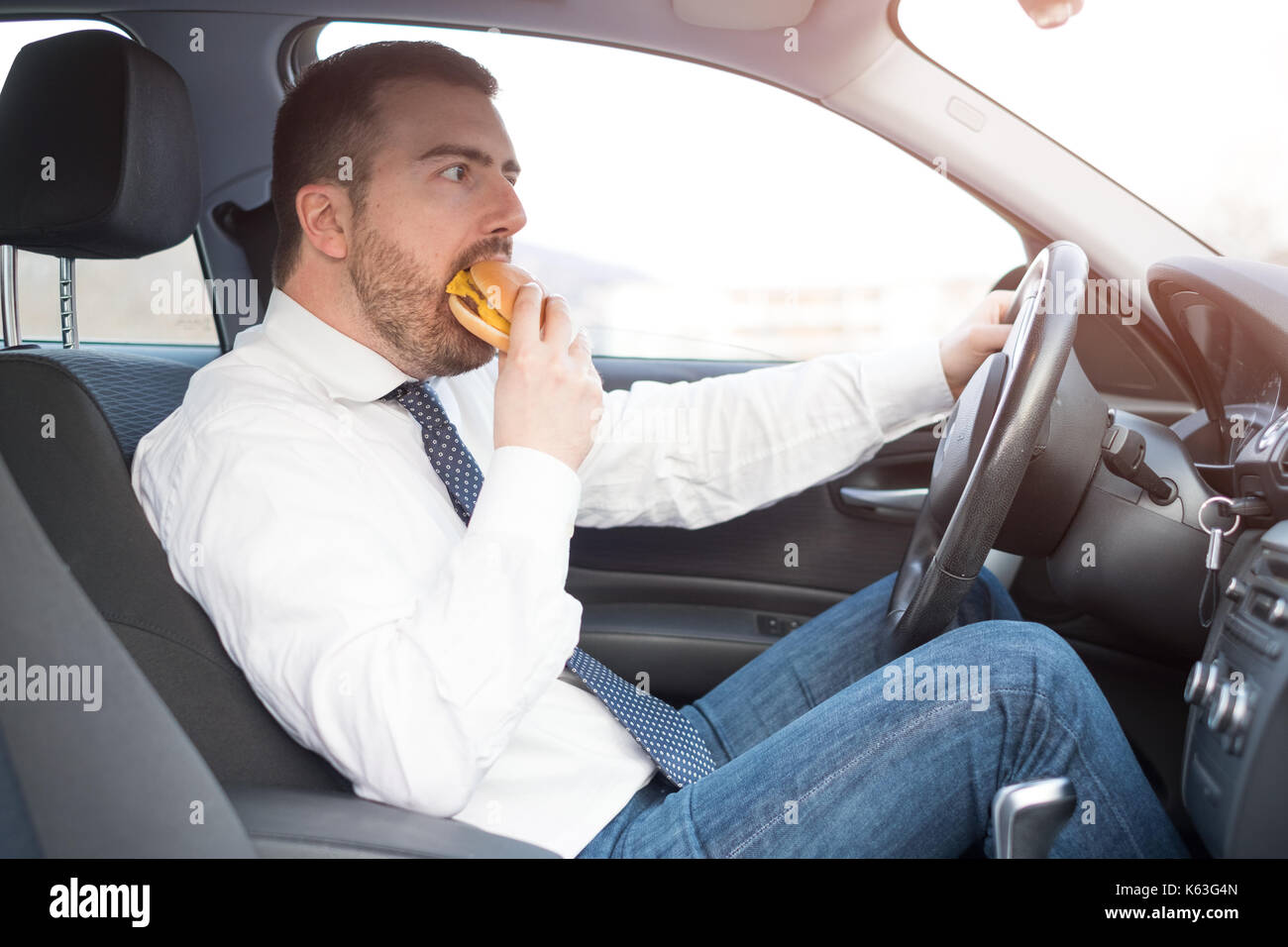 Man Eating Fast Food In A Car