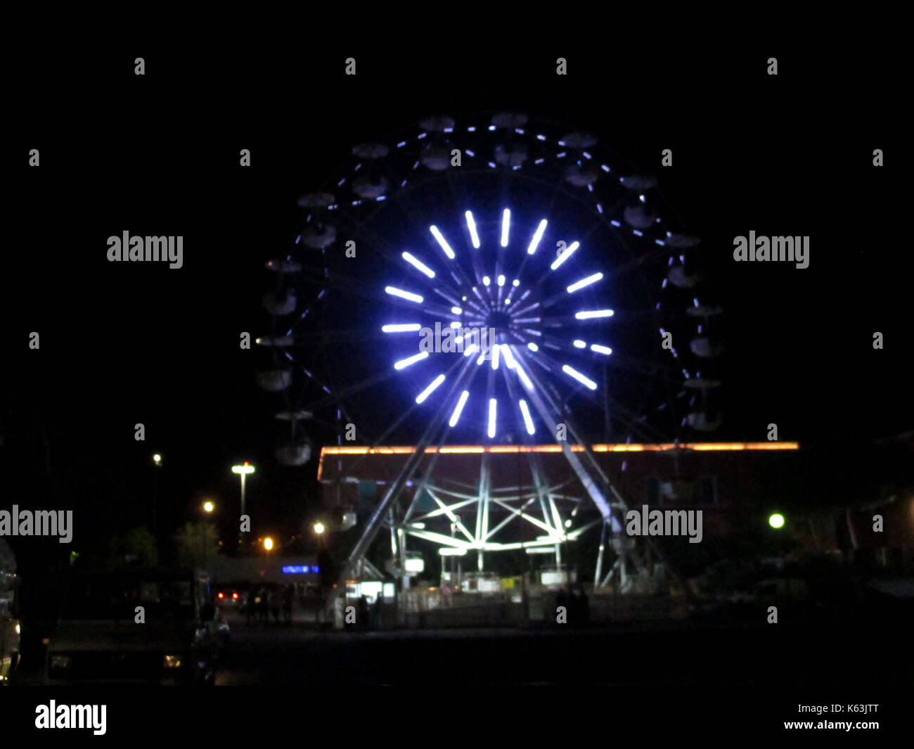 night shot carousel, panoramic wheel, illuminated Stock Photo - Alamy