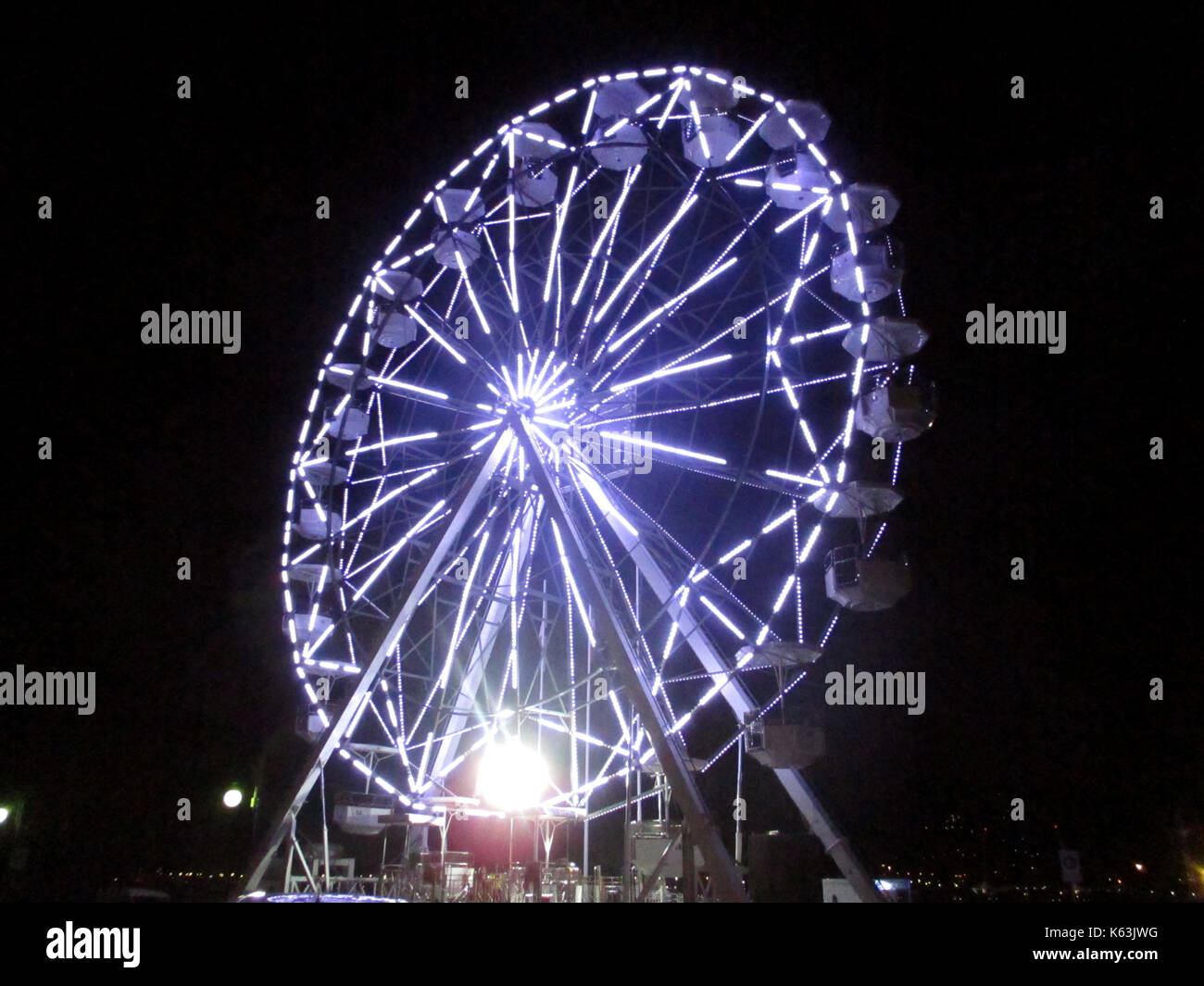 night shot carousel, panoramic wheel, illuminated Stock Photo - Alamy
