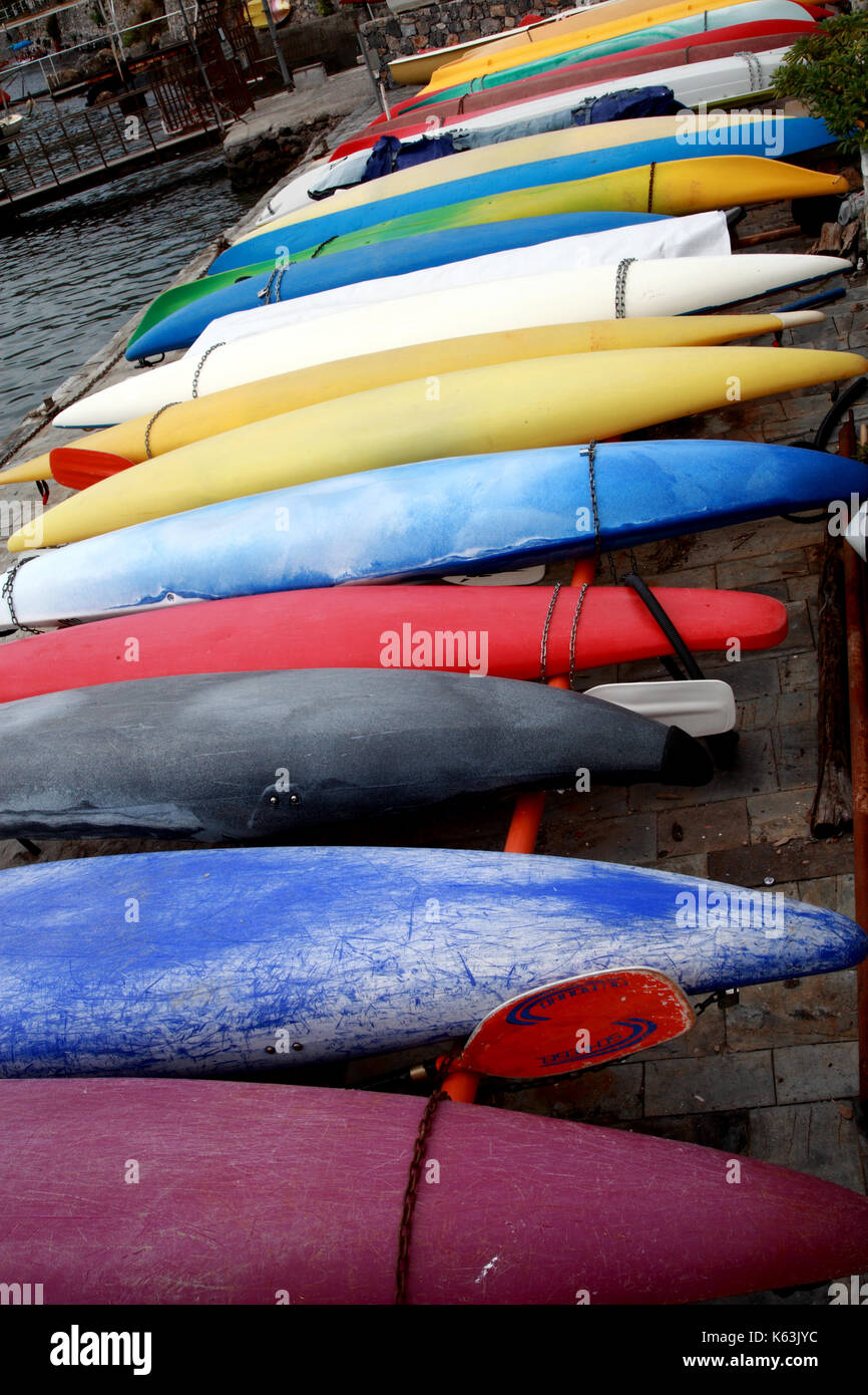 various colorful canoes turned on the mainland Stock Photo - Alamy