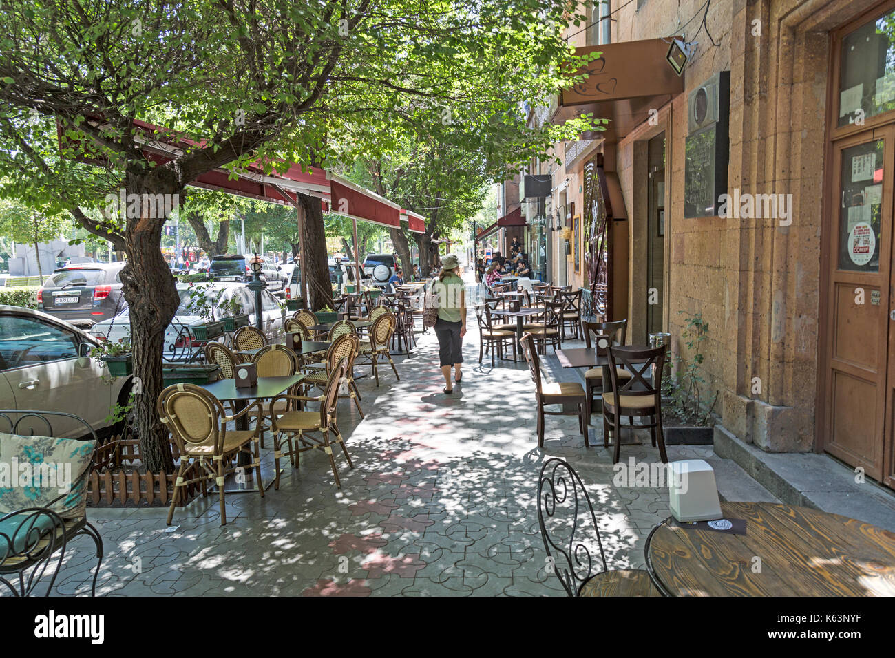 Tourist walking down a street in Yerevan in Armenia. Street has ...