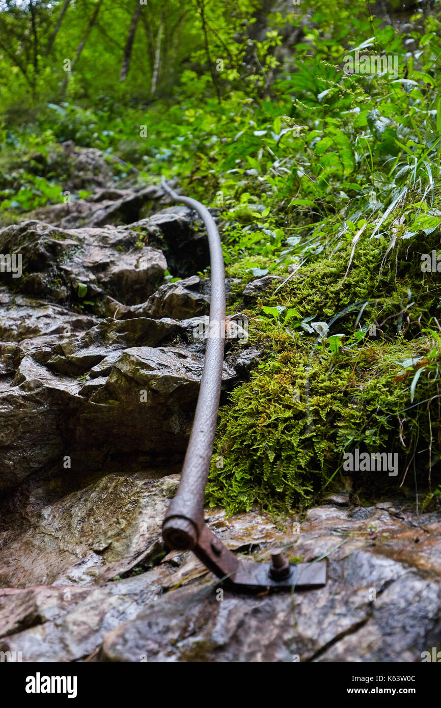 Safety cable on a vertical trail in the mountains Stock Photo - Alamy