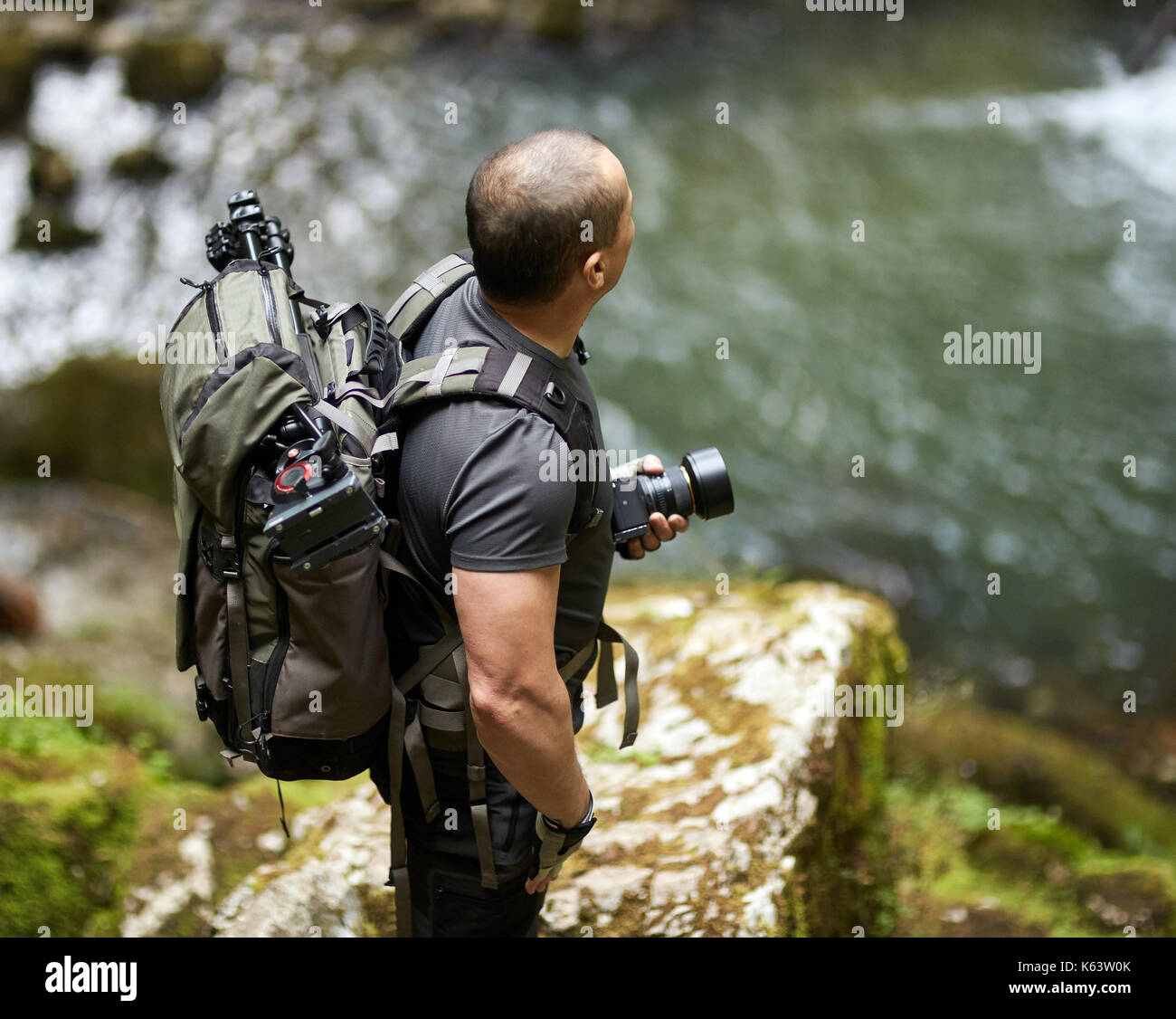 Professional nature photographer with backpack and tripod outdoor Stock ...