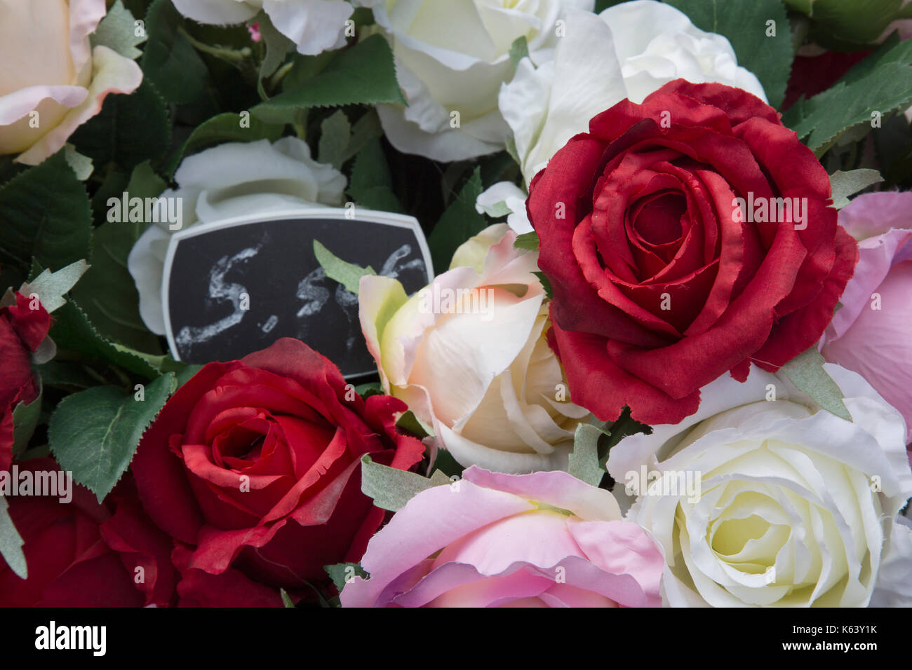 Red and White Roses for Sale on Market Stall Stock Photo - Alamy