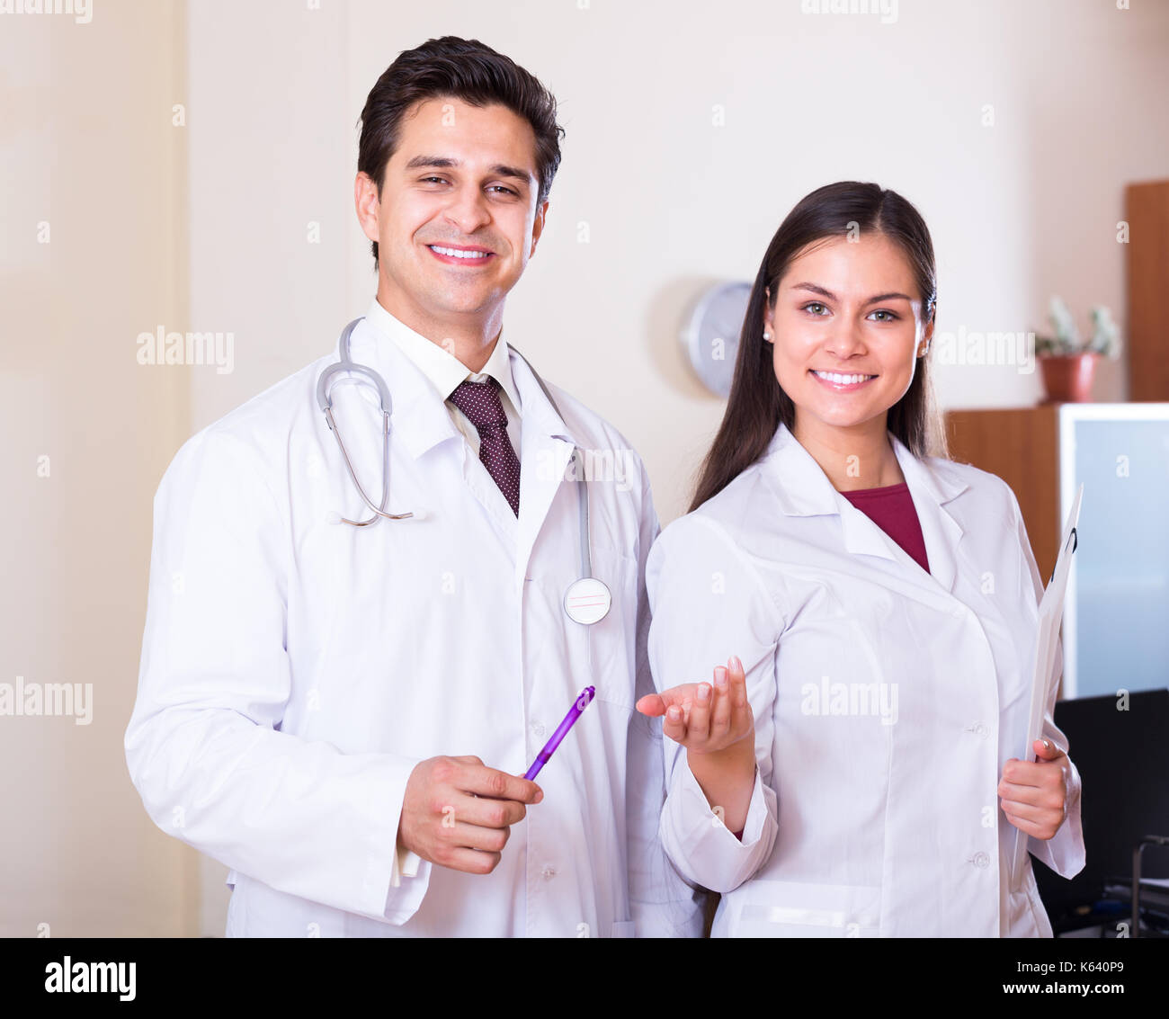 Portrait of two professional people smiling in clinic Stock Photo - Alamy