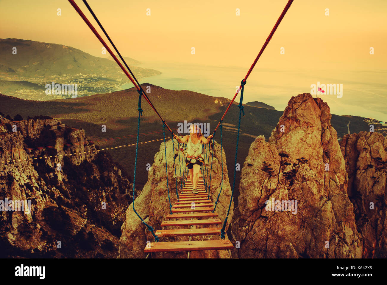 Woman is walking along a suspension bridge over an abyss. Yalta, the ...