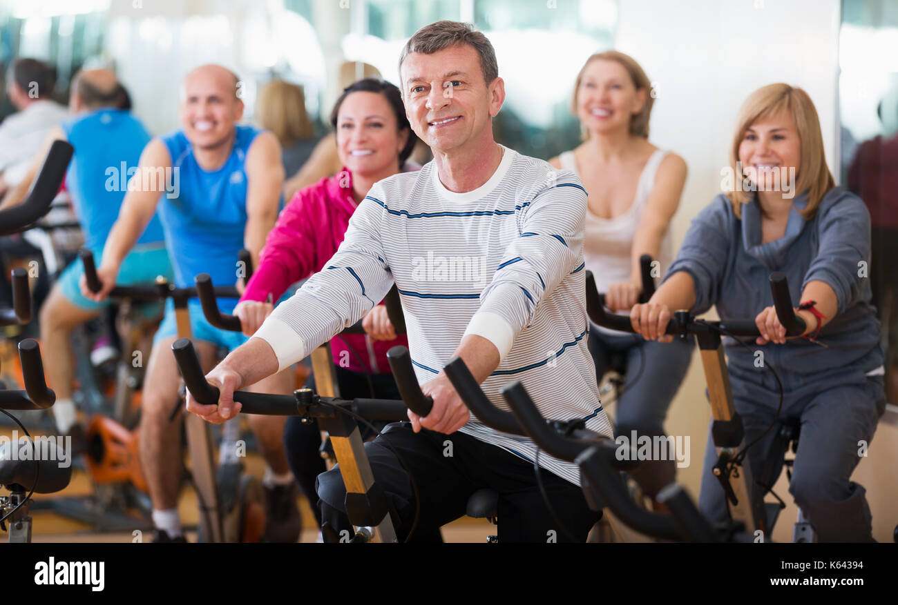 Group of active people cycling in a gym Stock Photo - Alamy