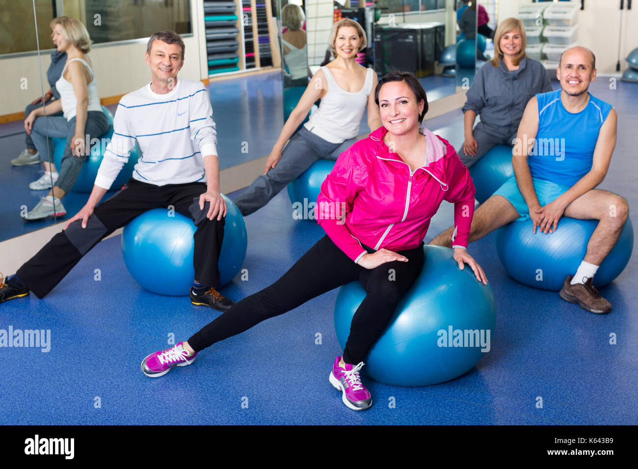 Elderly european people stretching in a gym on fitness balls Stock ...