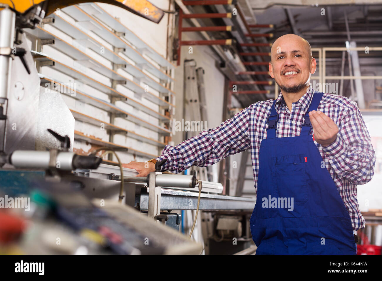 Portrait of middle age guy at professional lathe in plant Stock Photo ...