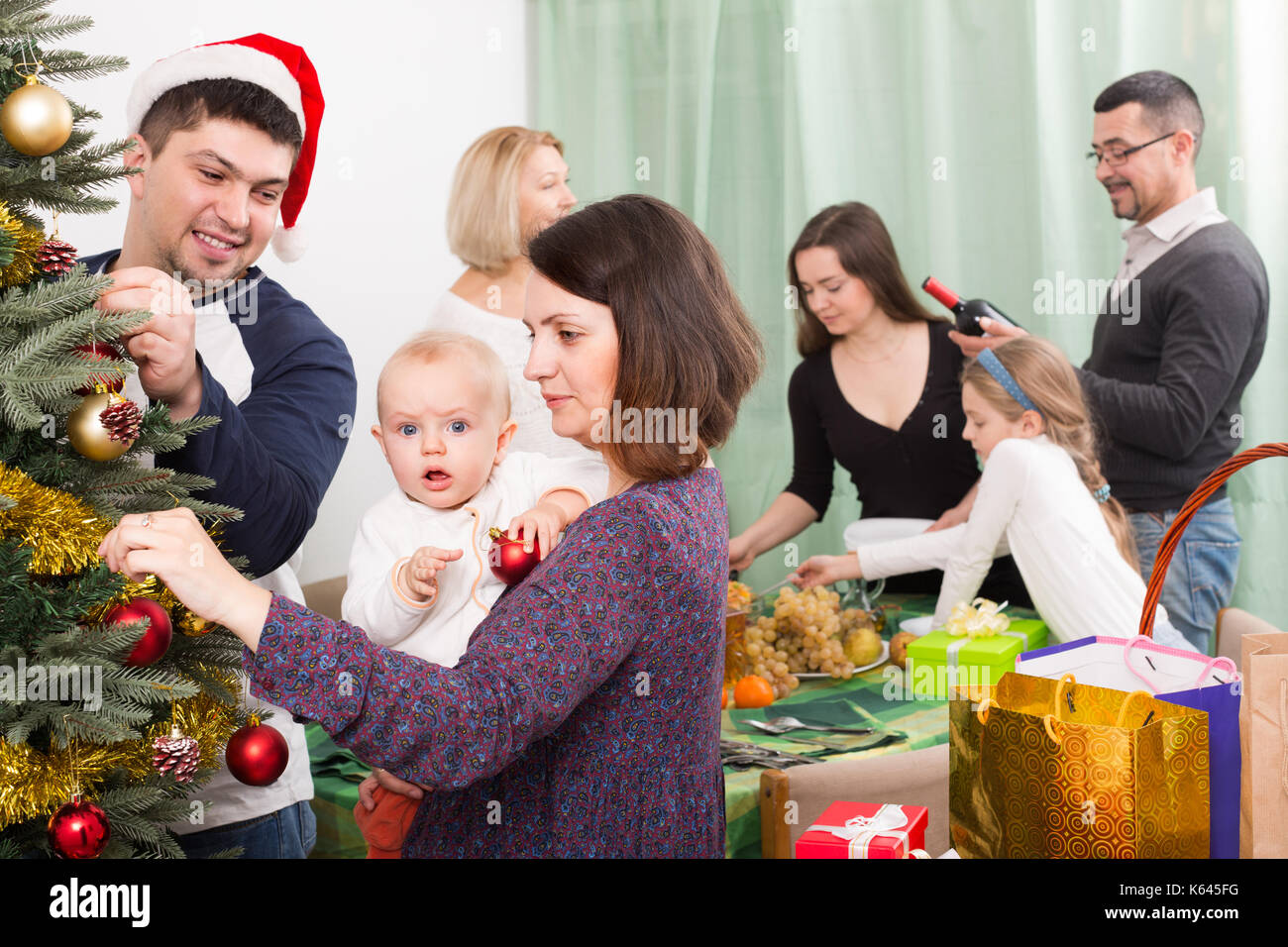 Happy smiling relatives gathered to celebrate Christmas with all family ...