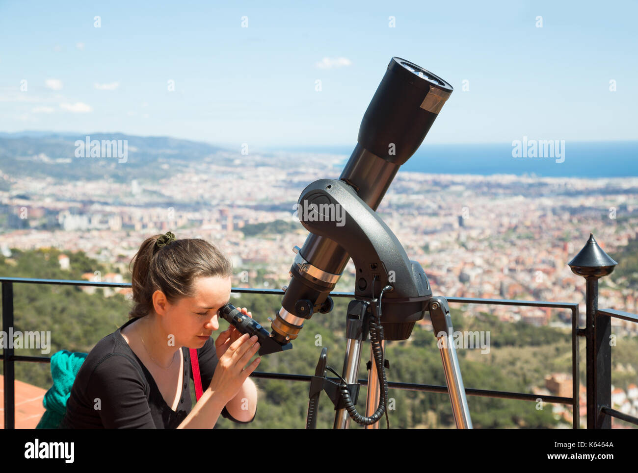 woman tourist looking in big telescope on sky desk Stock Photo - Alamy