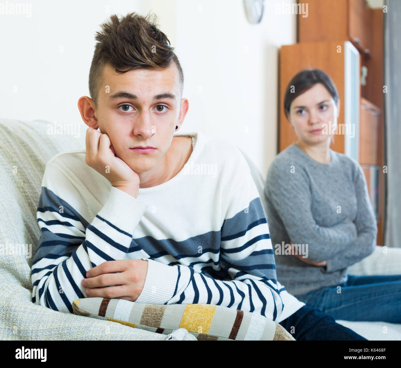 Upset mother and angry son arguing in domestic interior Stock Photo - Alamy