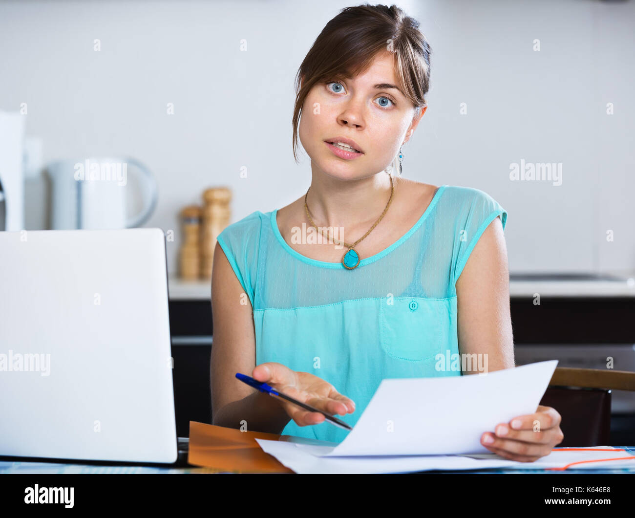 Sad young woman reading banking statement Stock Photo - Alamy