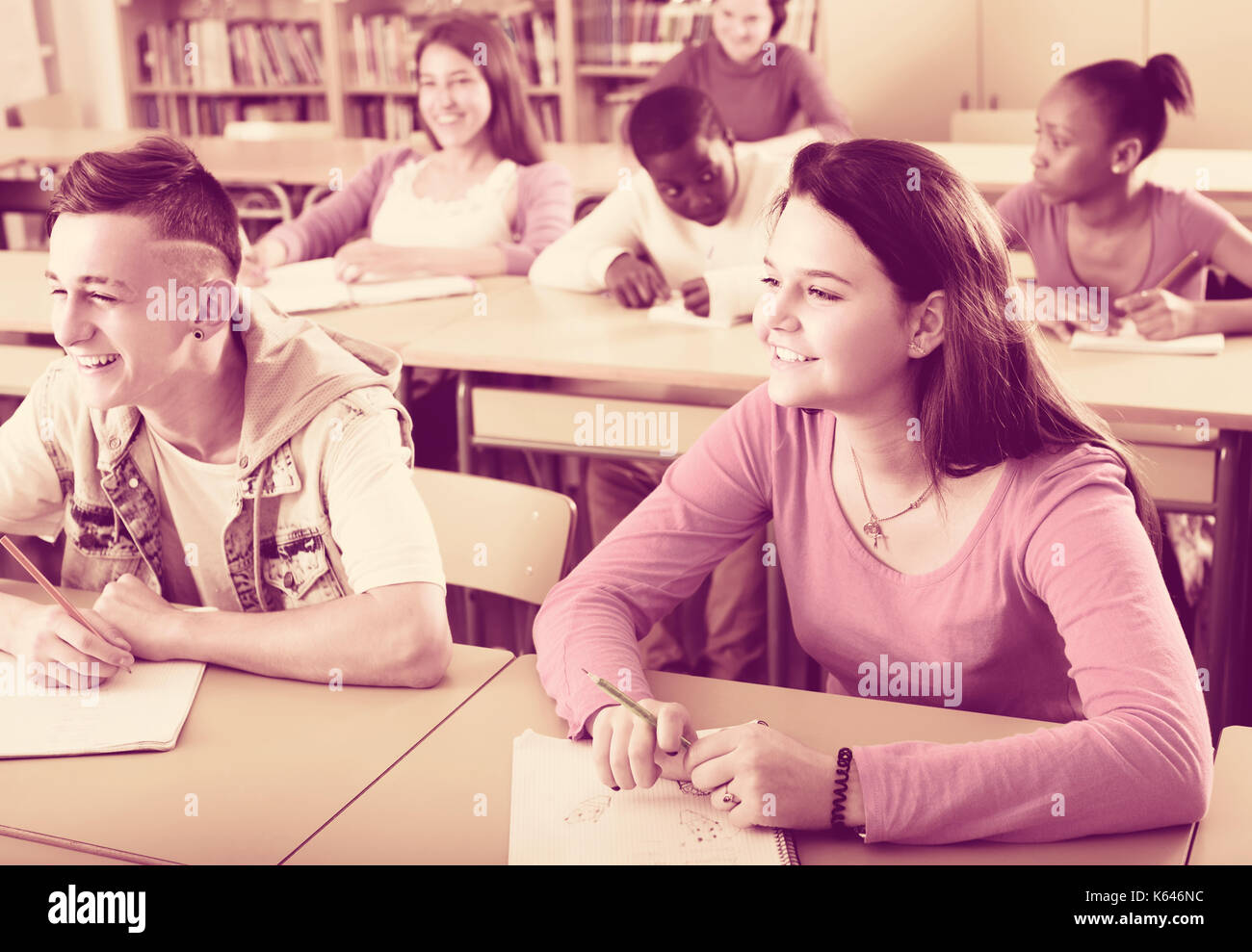 Group of cheerful smiling students making the notes at the lesson in ...