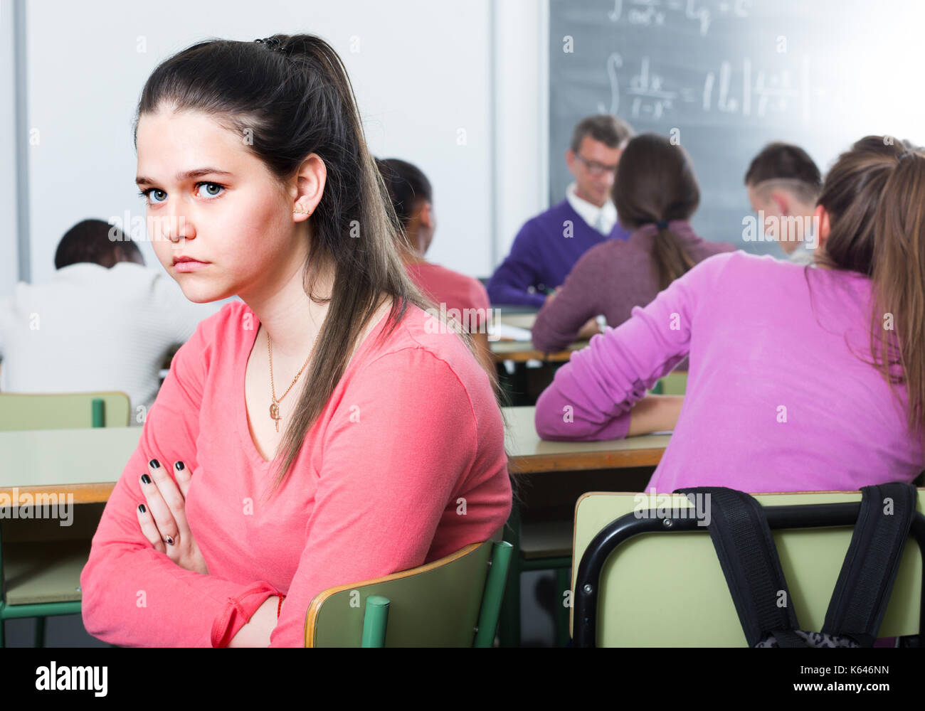 lonely student sitting away from classmates and feeling depressed ...