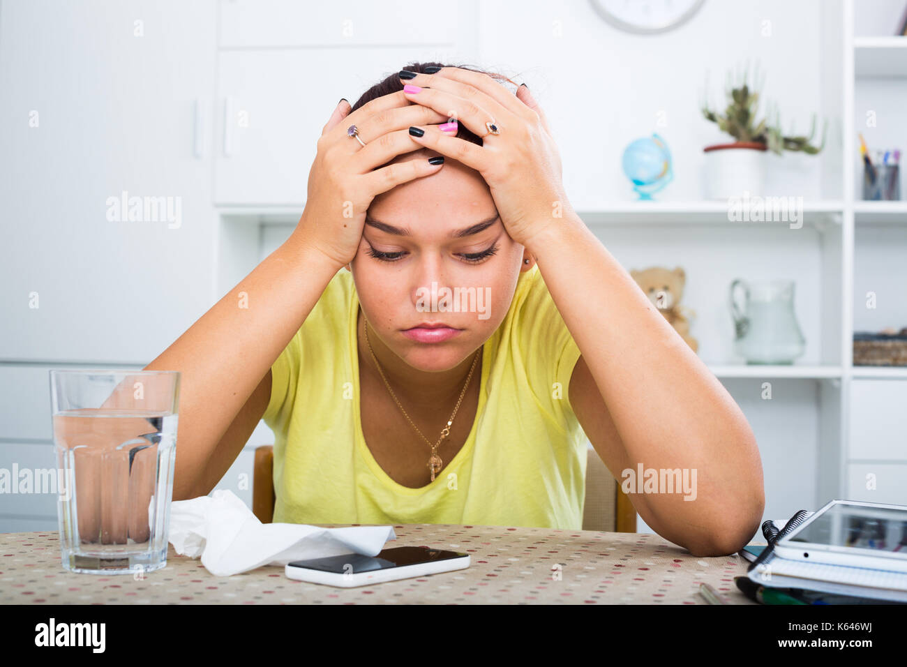 crying teenage girl looking at silent mobile phone indoors Stock Photo ...